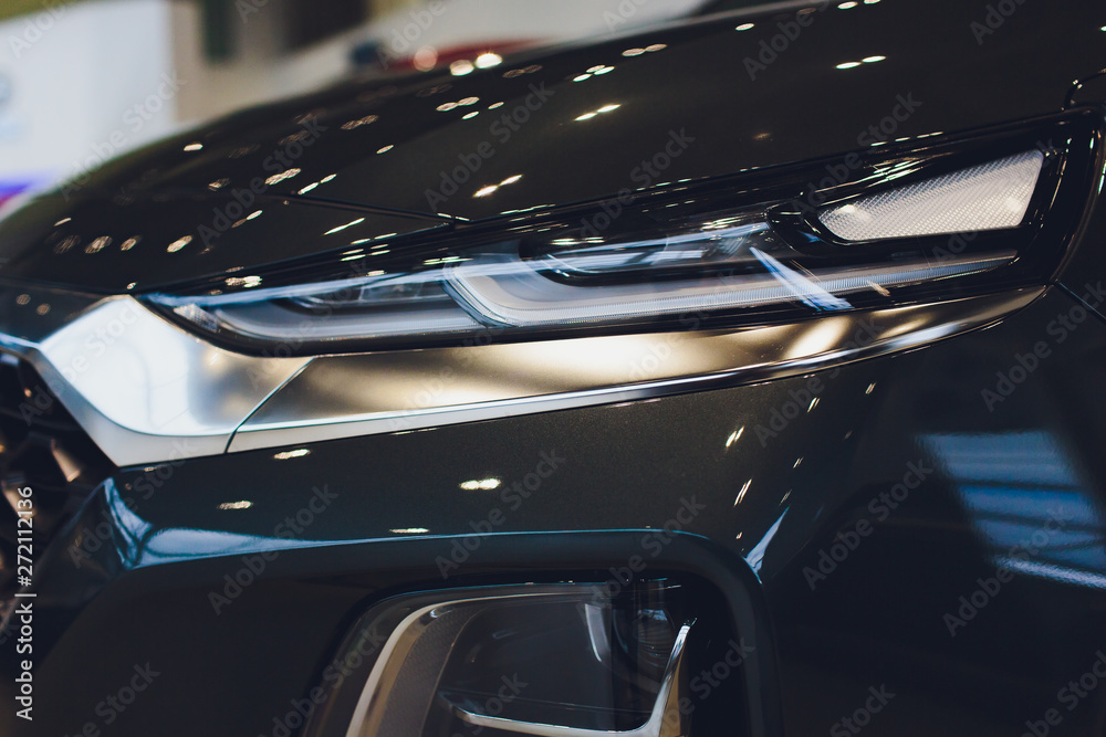 Close up of headlight detail of modern luxury car with projector lens ...