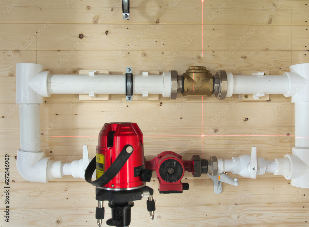 Foto Stock mounting of gravity heating system equipment with laser ...