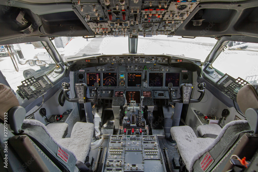 A view of the cockpit of a large commercial airplane a cockpit ...