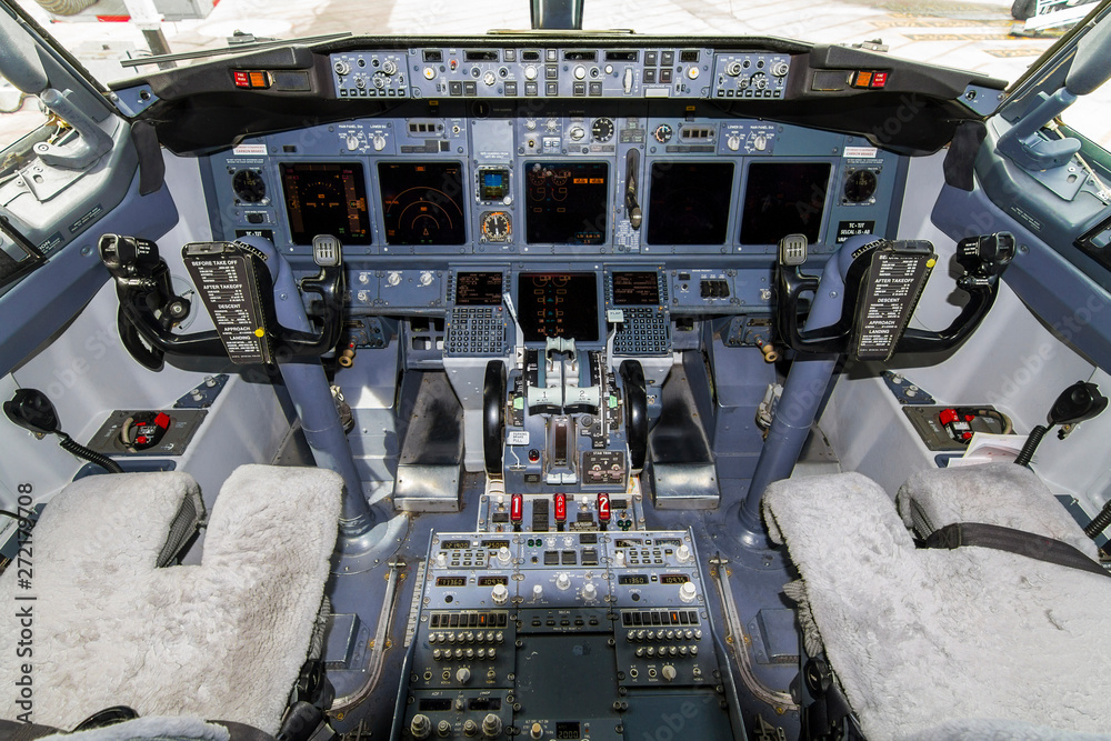A view of the cockpit of a large commercial airplane a cockpit ...