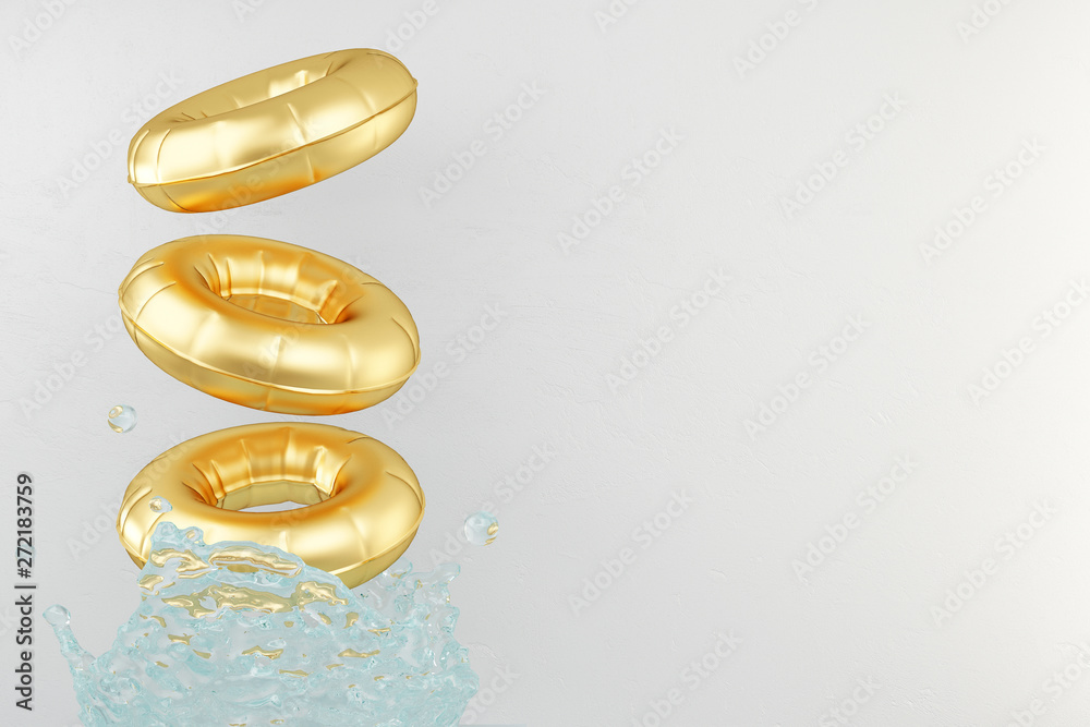 Gold swimming rubber rings on white background with water splashes. A ...