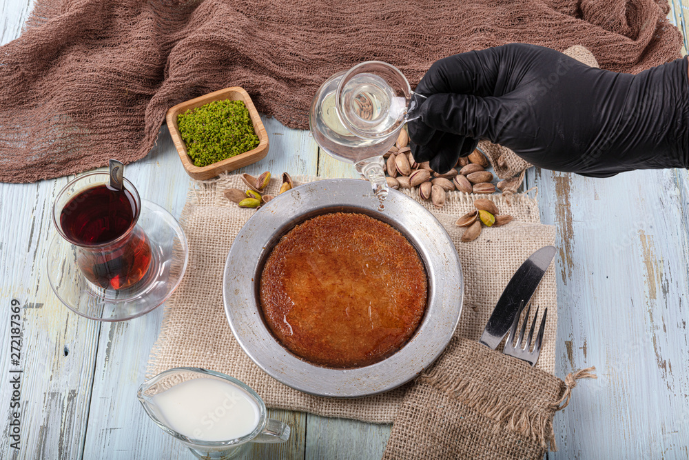 Turkish dessert kunefe, kunafa, kadayif with pistachio powder and ...
