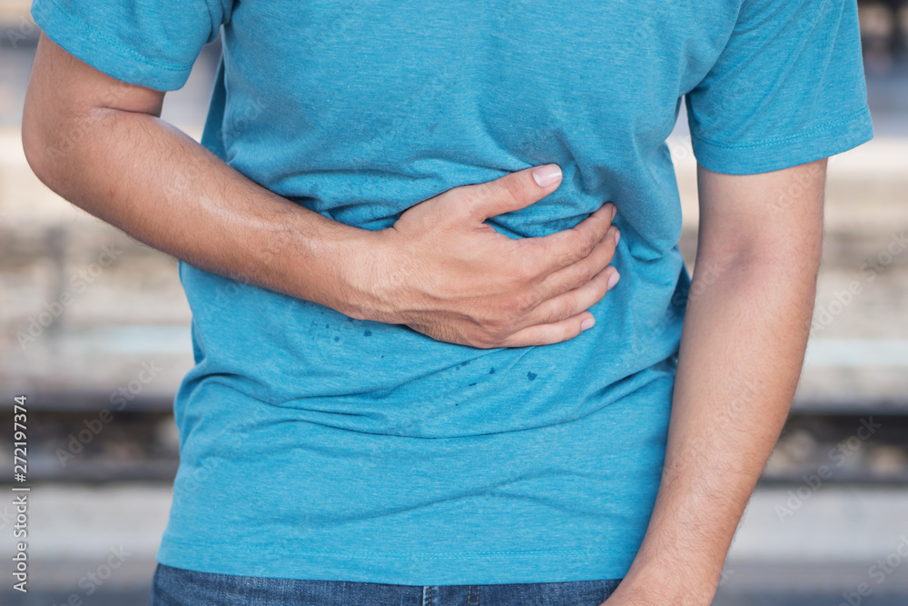 sick man suffers from stomach ache, diarrhea, constipation, indigestion ...