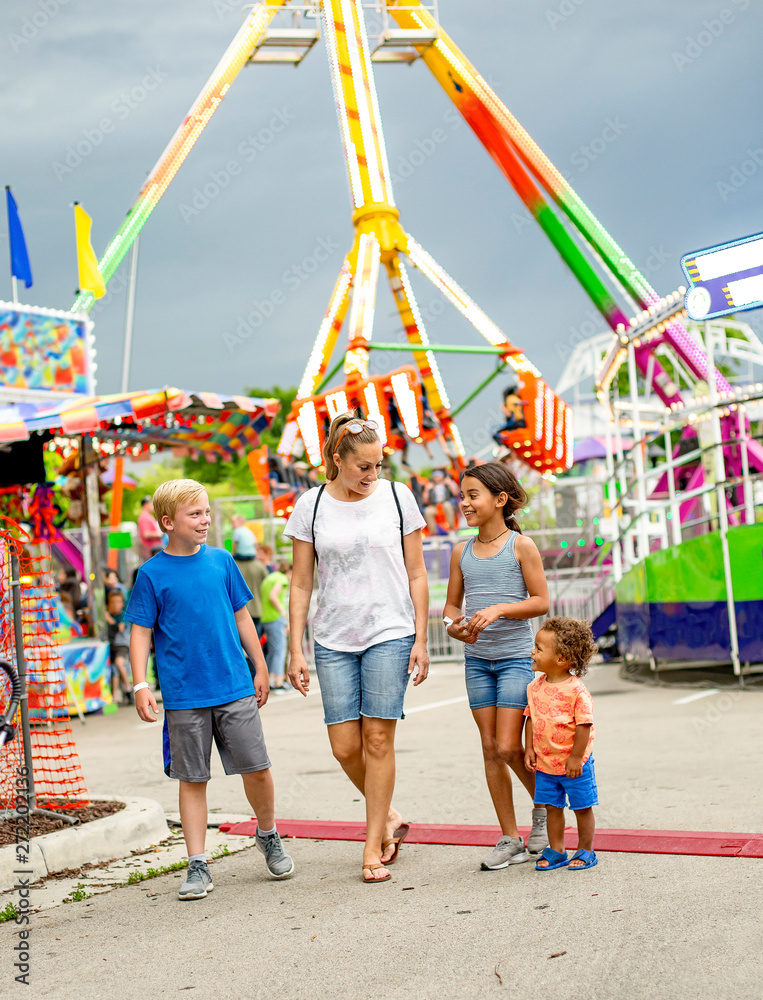 Candid photo of a smiling family group having fun at an outdoor ...