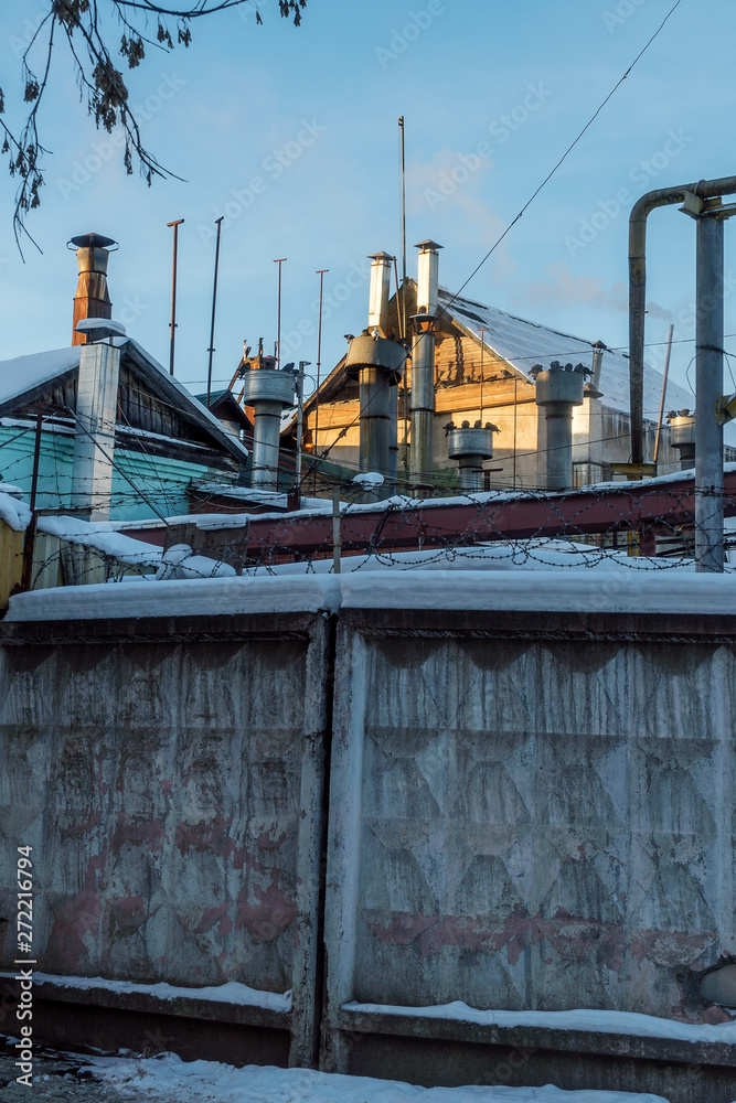 In front of us behind a dilapidated concrete fence with barbed wire is ...