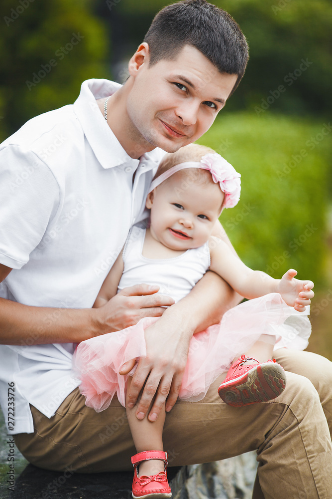 Young father walking with his little child outdoors. Dad taking care of ...