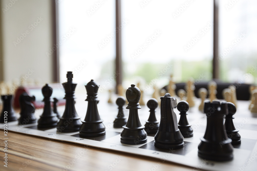 Arranged wooden chess pieces standing in perfect order on table in ...