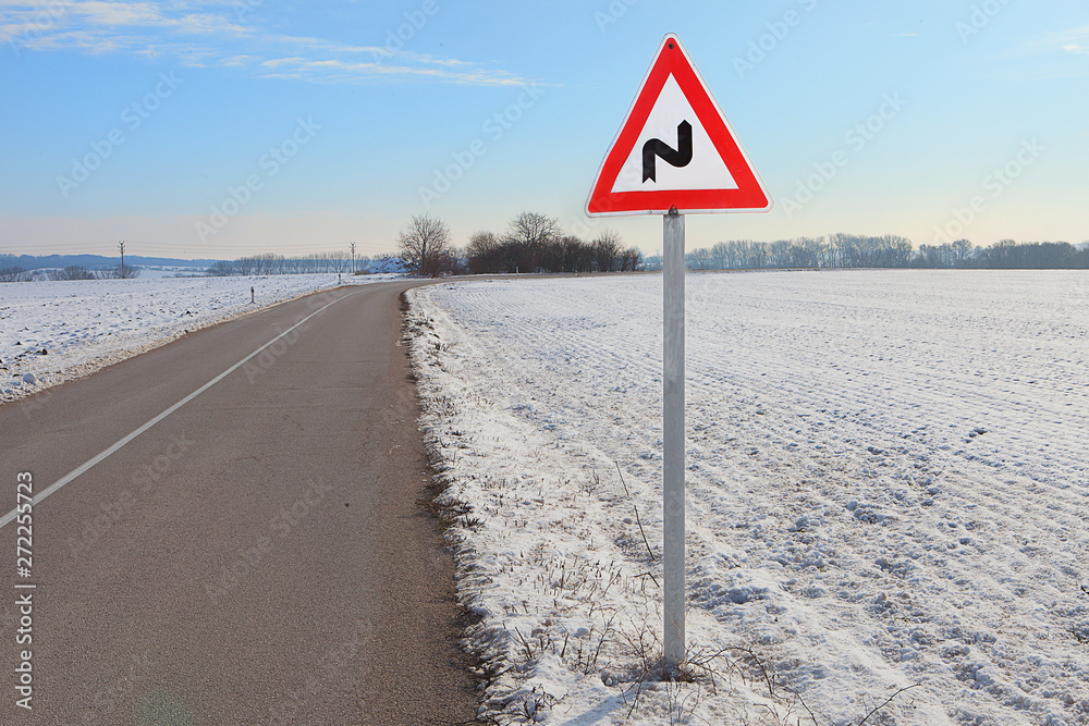 Double bend ahead right then left road sign in winter land. Warning on ...