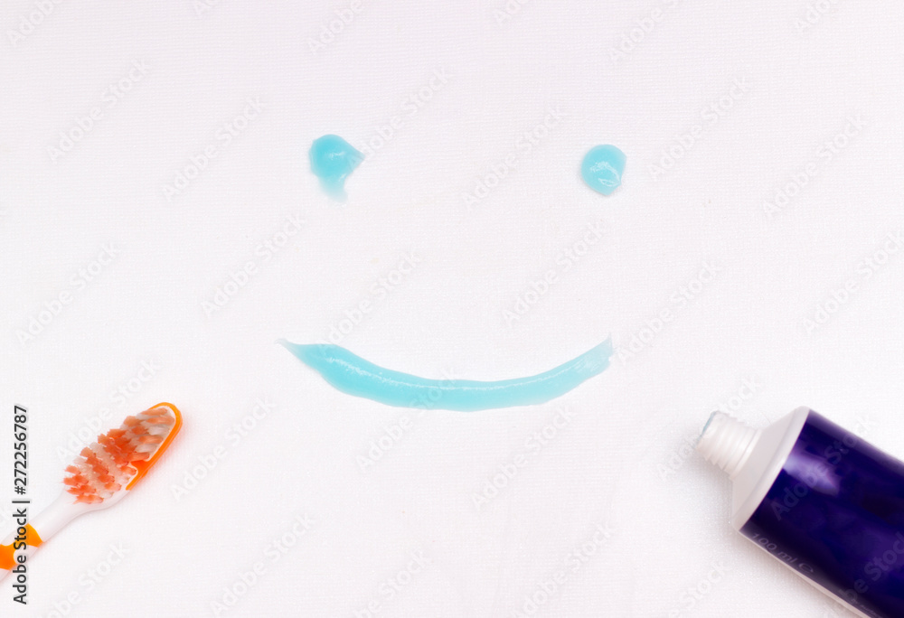 Tooth-paste in the form of face with a smile. Tube of toothpaste and ...