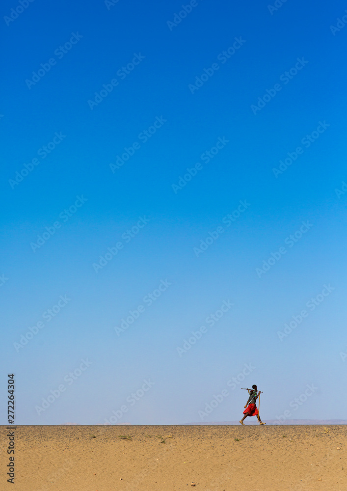 Afar tribe man walking alone in the desert, Assayta, Ethiopia Stock ...