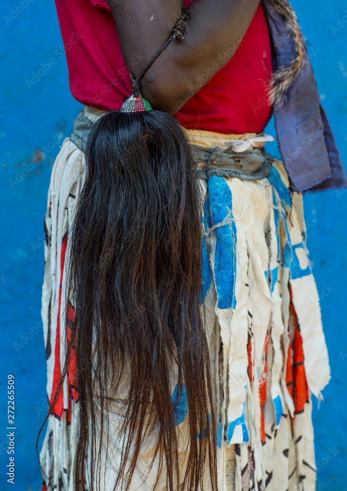 Man from anuak tribe in traditional clothing holding a flyswatter ...