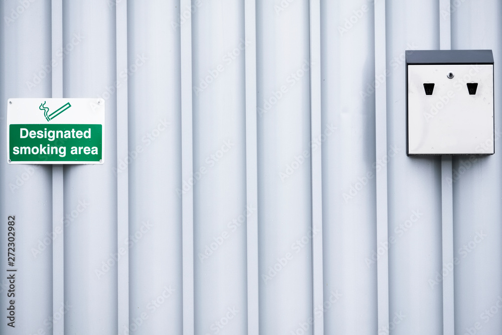 Designated smoking area sign and ash tray at office place of work Stock ...