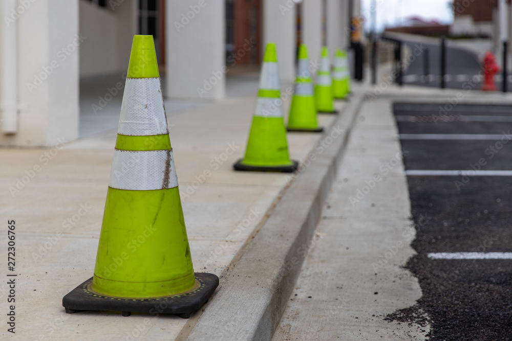 Traffic cones line up in a parking lot Stock Photo | Adobe Stock