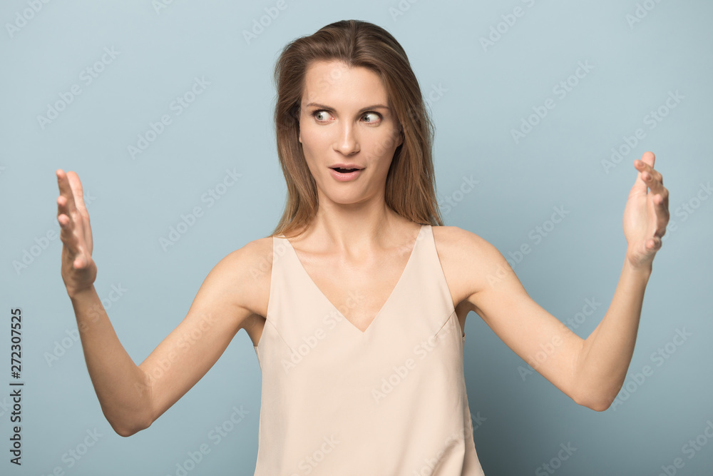 Surprised funny woman showing huge, big size gesture with hands Stock ...