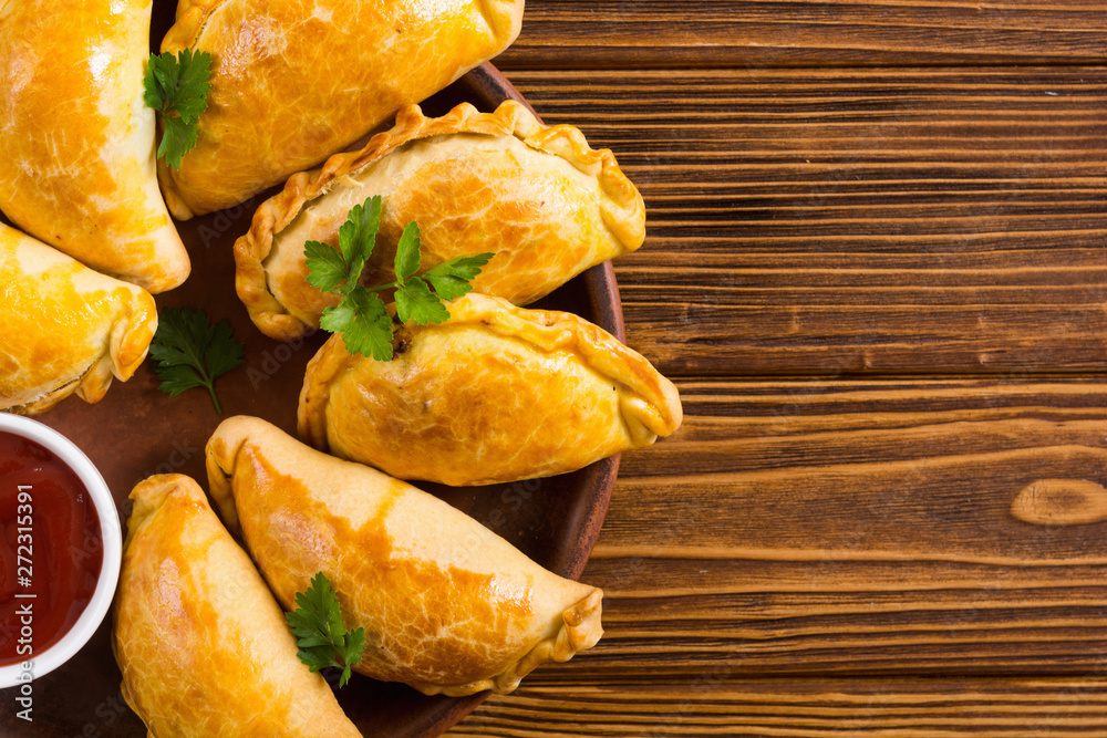 Latin American baked beef empanadas with sauce Stock Photo | Adobe Stock