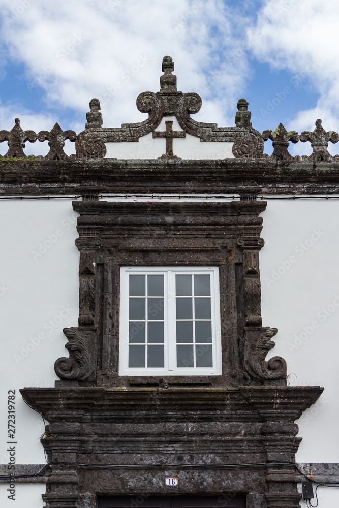 Typical Azorean architecture. White wooden window surrounded with ...