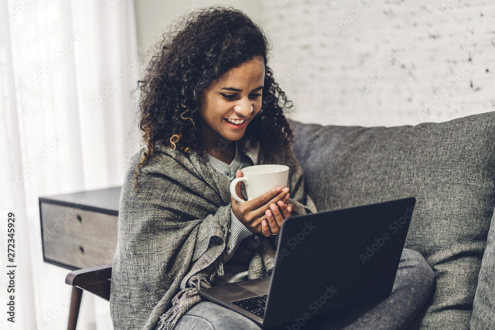Young african american black woman relaxing and using laptop computer ...