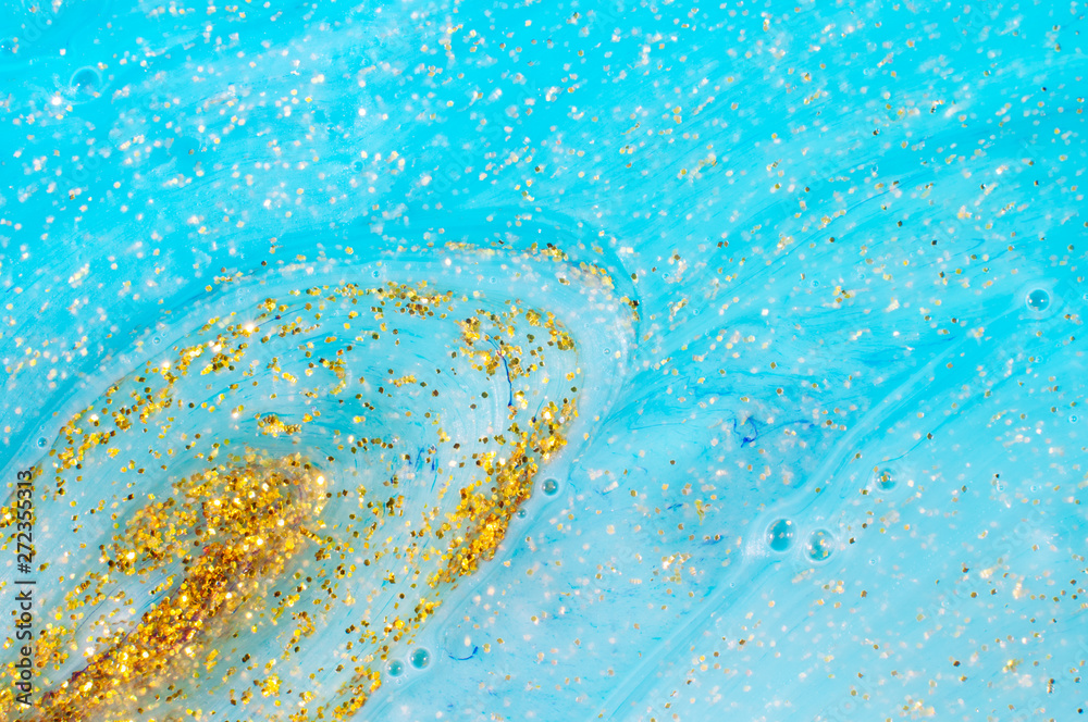 Abstract textured background blue slime with golden glitter particles ...