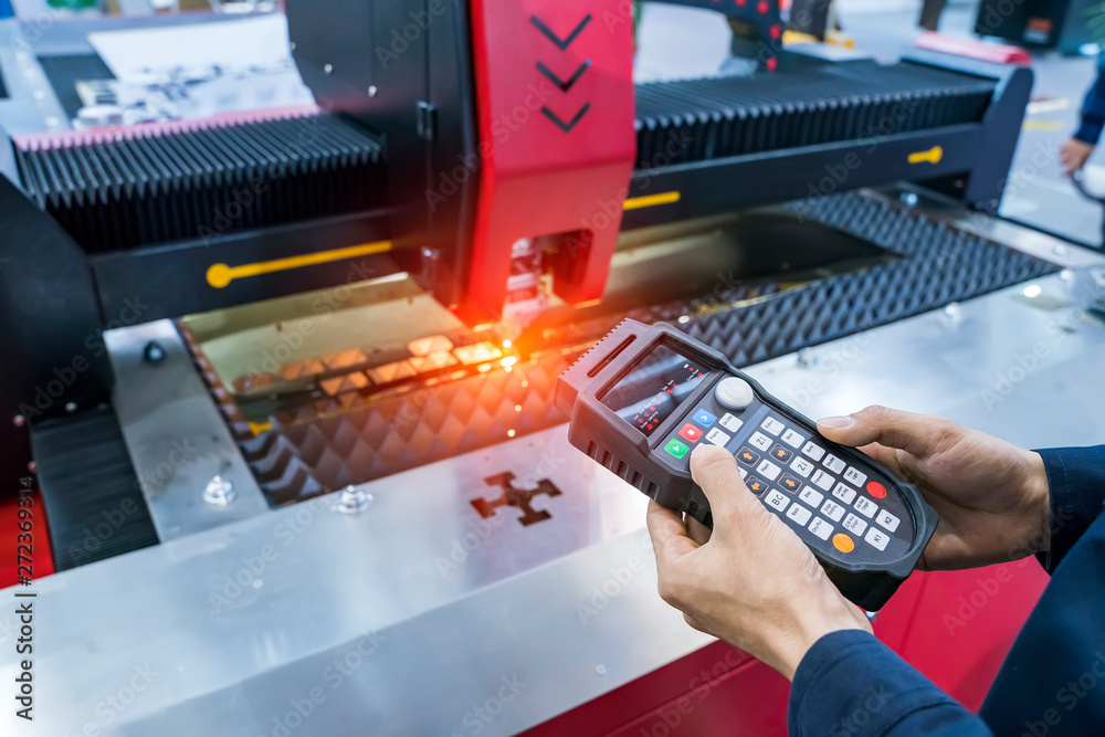 worker holding smart pannel to control Laser cutting of metal sheet, 3D ...