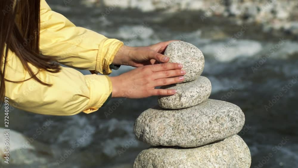 Female hands putting stone on balance pyramid. Faceless woman holding ...