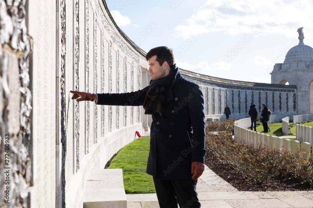 Man at military cemetery pointing at grave of deceased relative Stock ...