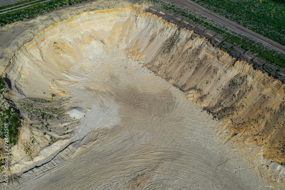 Aerial view of the steep high slope of a sand pit in Germany, abstract ...