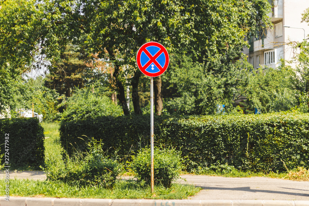 Red and blue round road sign that restricts certain maneuvers in nature ...