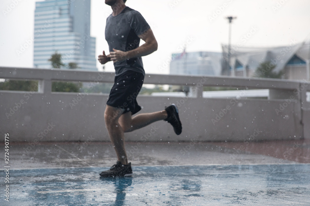 Faceless Man Running in the Rain Stock Photo | Adobe Stock