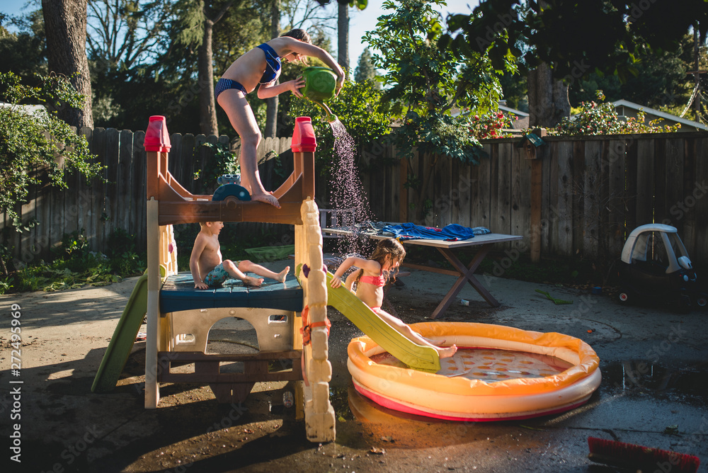 Little kids playing in the backyard with kiddy pool. Stock Photo ...