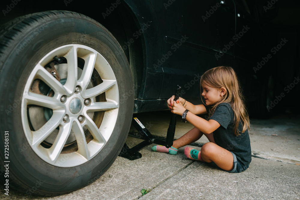 child changes tire on car Stock Photo | Adobe Stock