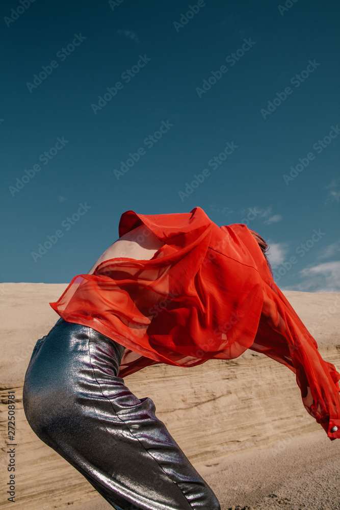 Anonymous model in strange clothes dancing under sun Stock Photo ...