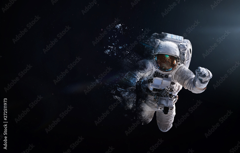 Astronaut breaks up into particles in space. Abstract wallaper ...