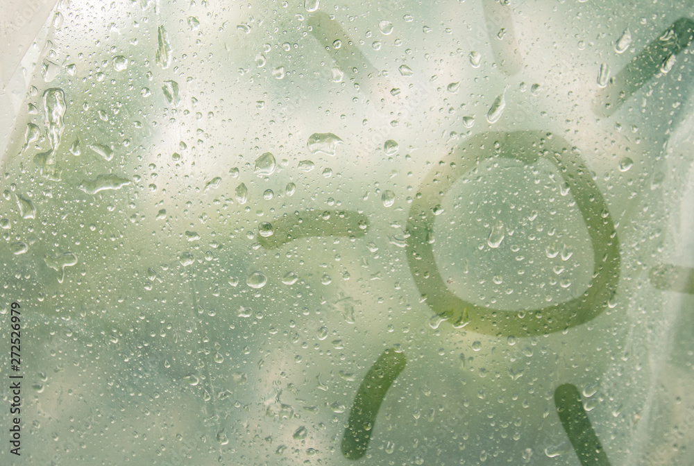 Drawing a finger-shaped strip of the sun on a translucent, misted glass ...