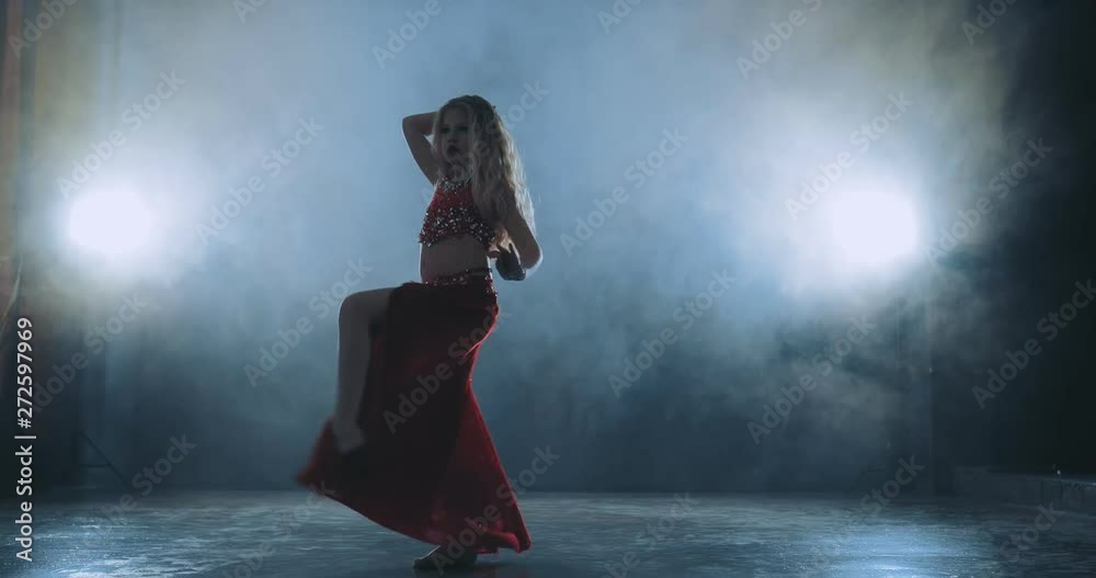 Young girl the blonde dances Arab dance, beautiful movements with legs ...