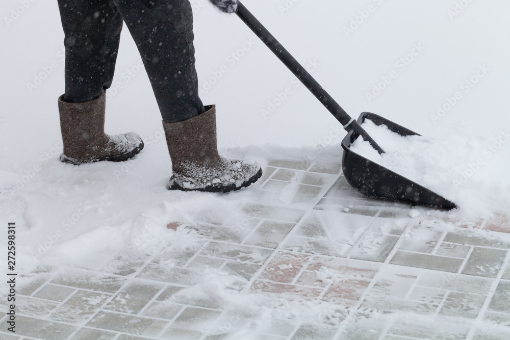 Legs of old woman wich clears a snowdrifts with a snow shovel Stock ...