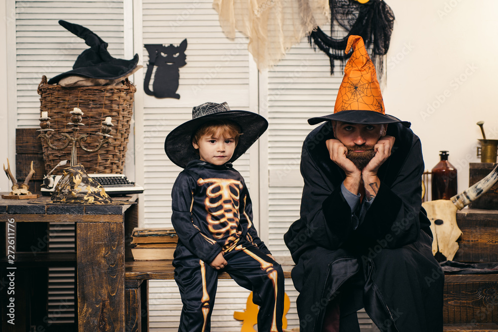 Sad party. Boring Halloween at home. Father and son in carnival ...