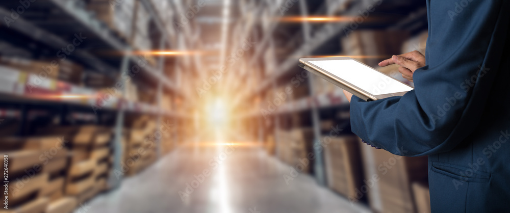 Factory worker using application on smart tablet to operate automation ...