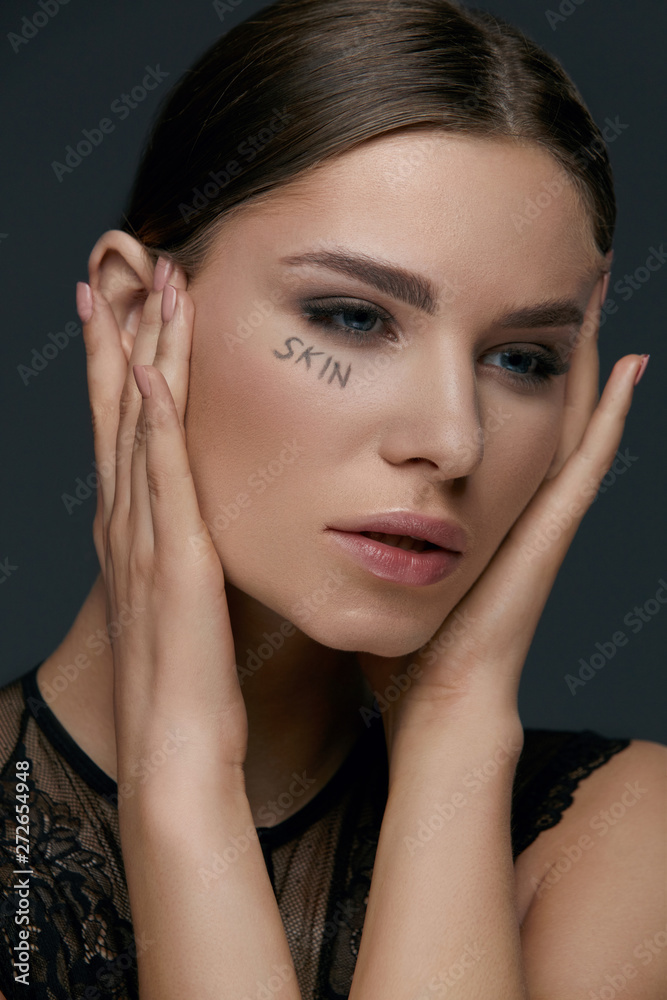 Skin beauty. Woman face with makeup and skin word closeup Stock Photo ...