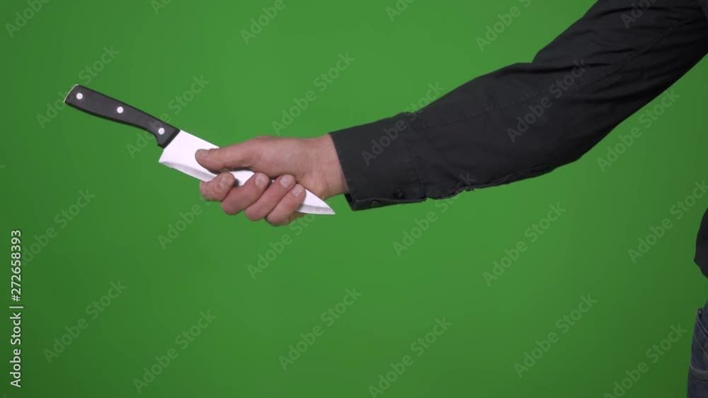 man make bad decision and makes a handshake with a kitchen knife. green ...