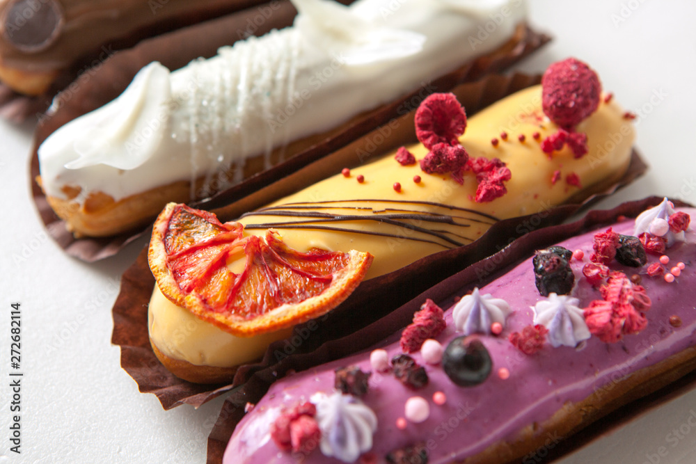 Set of several eclairs with various fillings and design isolate on a ...