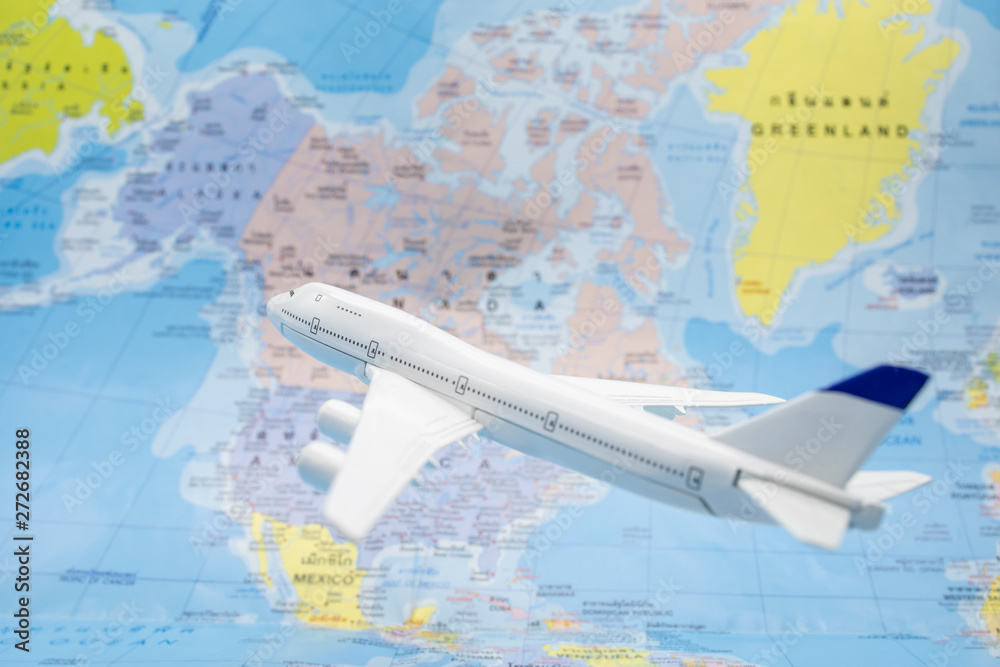 Travel and transport concept. Toy airplane fly over on colorful world ...