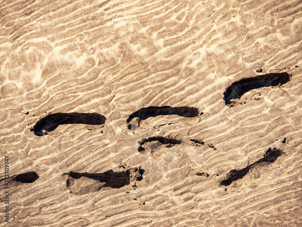 Deep footprints in a sand, Sand texture, High contrast light. Sepia ...