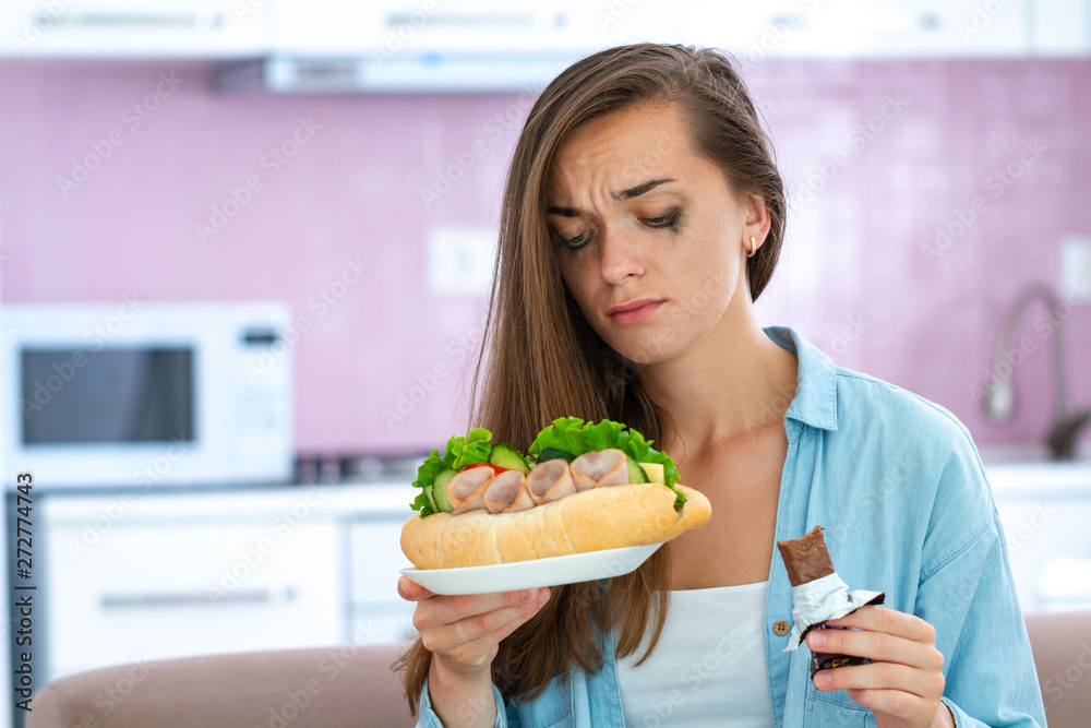 Sad, unhappy stressed crying woman eating unhealthy junk food and ...