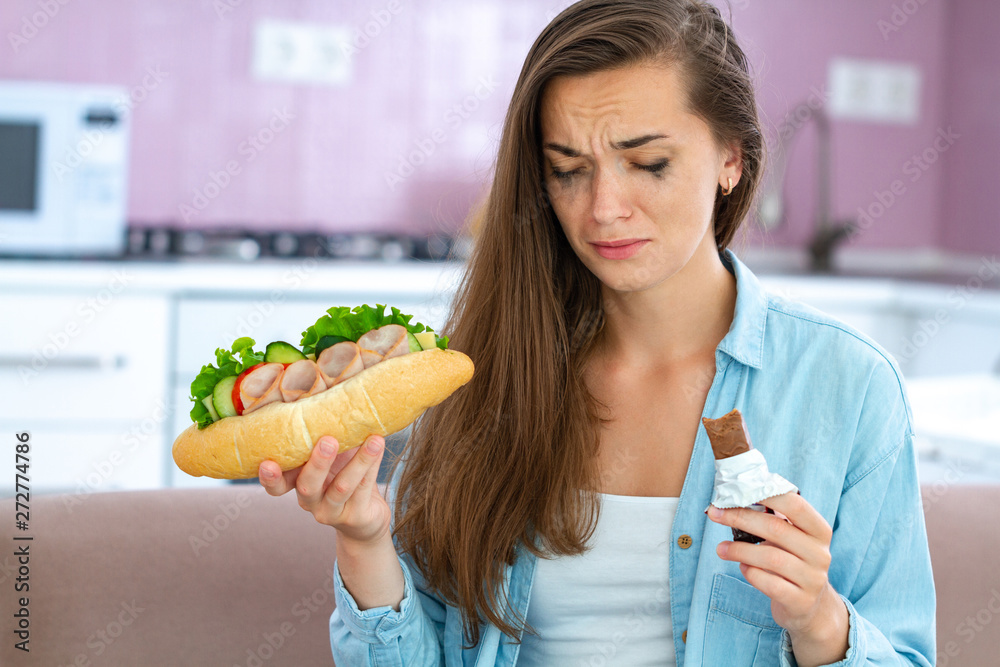 Unhappy stressed crying woman eating unhealthy food and chocolate ...