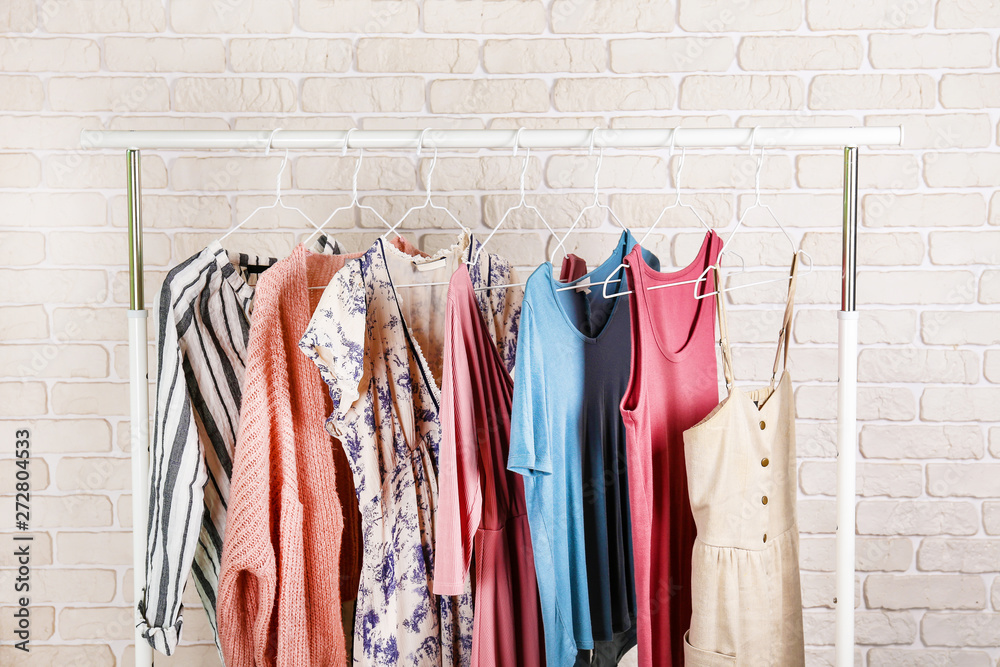 Women's hip clothing store interior concept. Row of different colorful ...