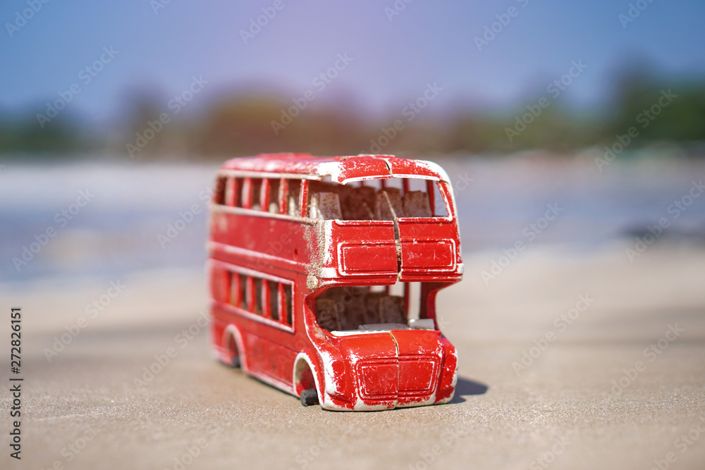 Red toy bus in nature pollutes the earth's ecosystem. English bus ...