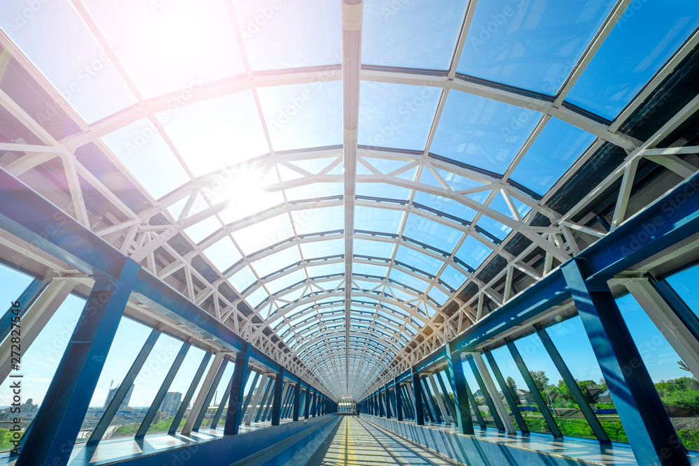 Tunnel bridge for pedestrians. Modern glass footbridge. Transparent ...