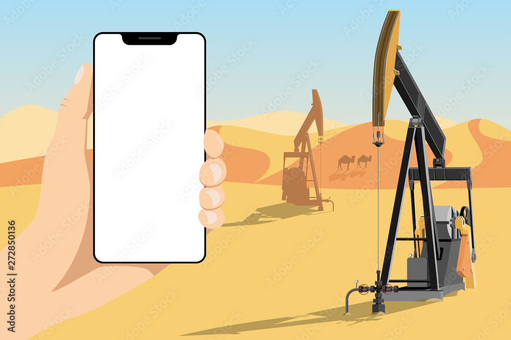 Hand with phone on the background of oil rigs in the desert. White ...