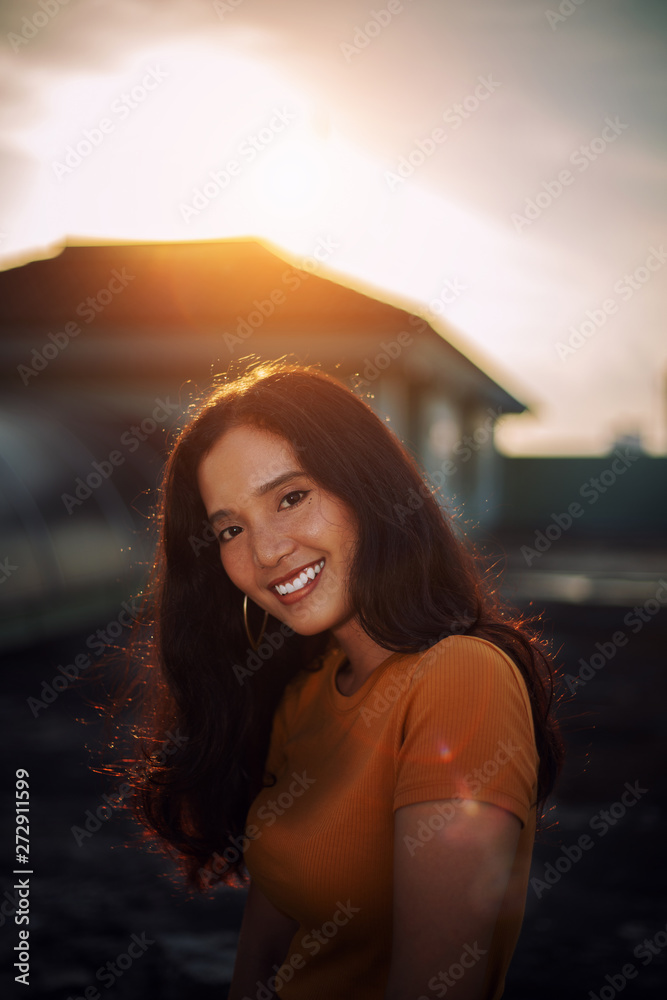 The girl has a skin color of honey or tan. Wearing orange shirt Street ...