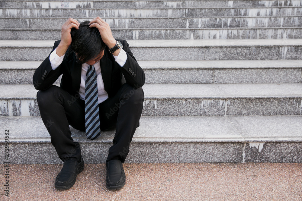 Asian businessmen with headaches or migraines at the city hall after ...